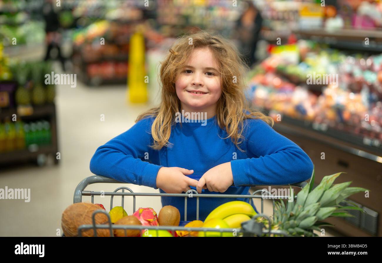 Child shopping in grocery store. Kid in supermarket. Child with ...