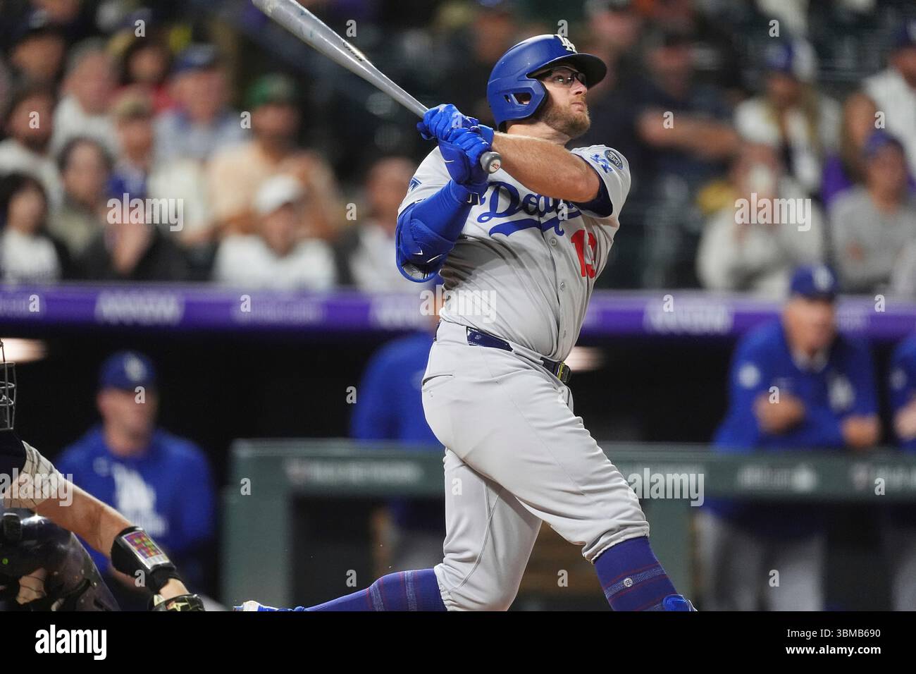 Los Angeles Dodgers' Max Muncy follows the flight of his grand slam off ...