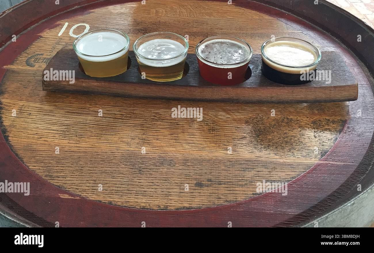 Beer tasting tray of four craft beers on top of a barrel at Kangaroo ...
