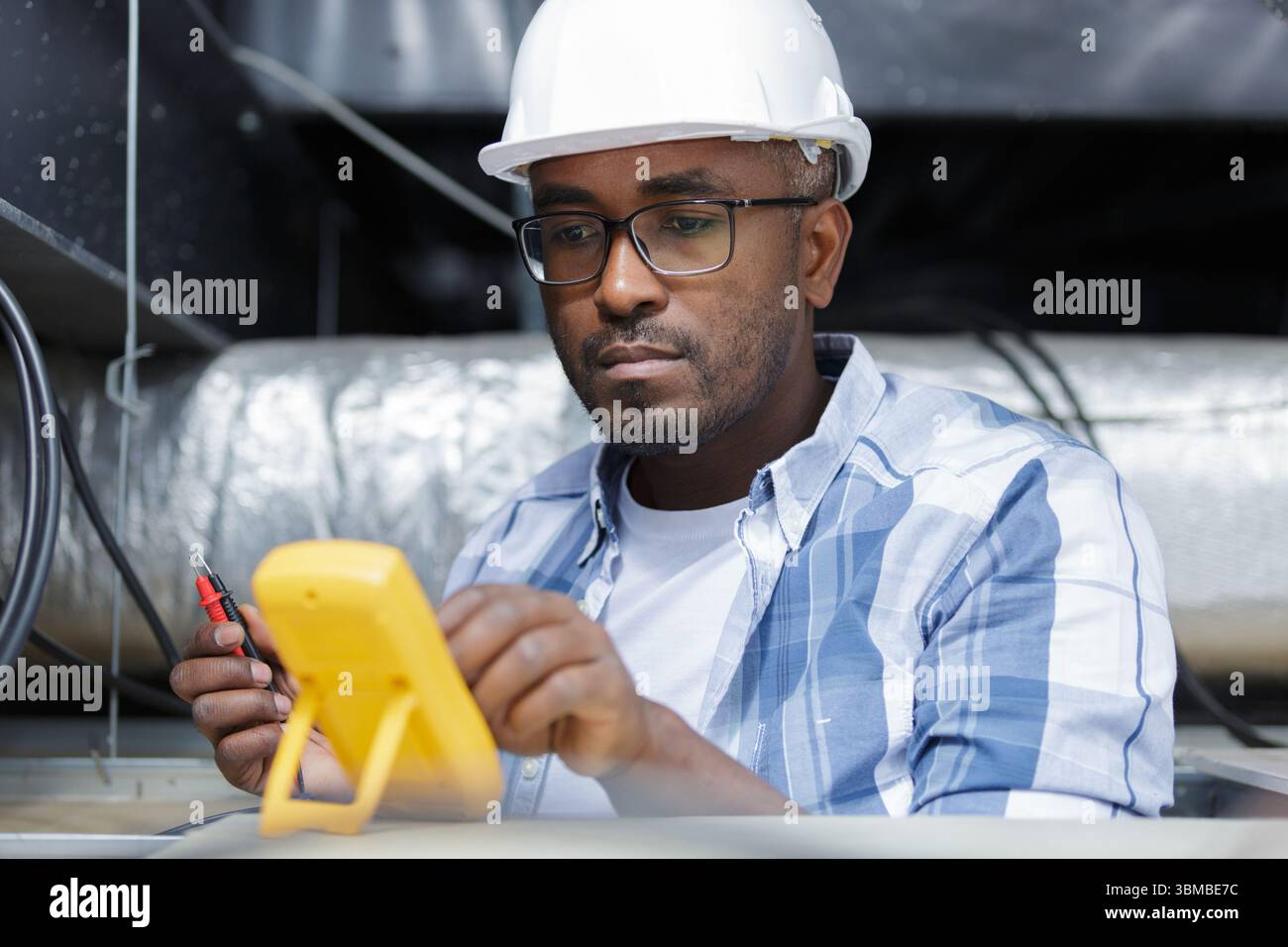 electrical student checks high voltage cable Stock Photo - Alamy