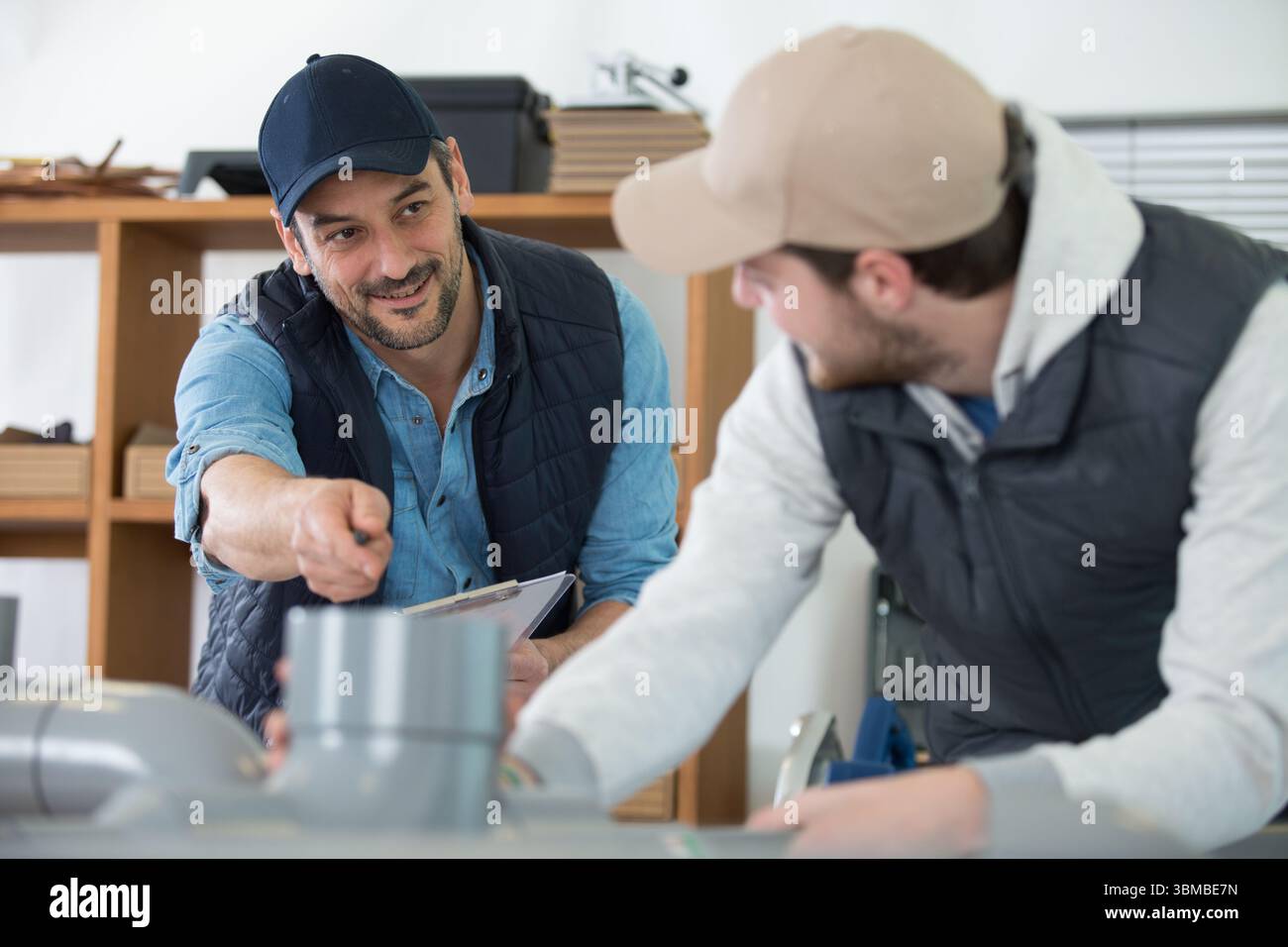 teacher with student in metallurgy workshop Stock Photo - Alamy