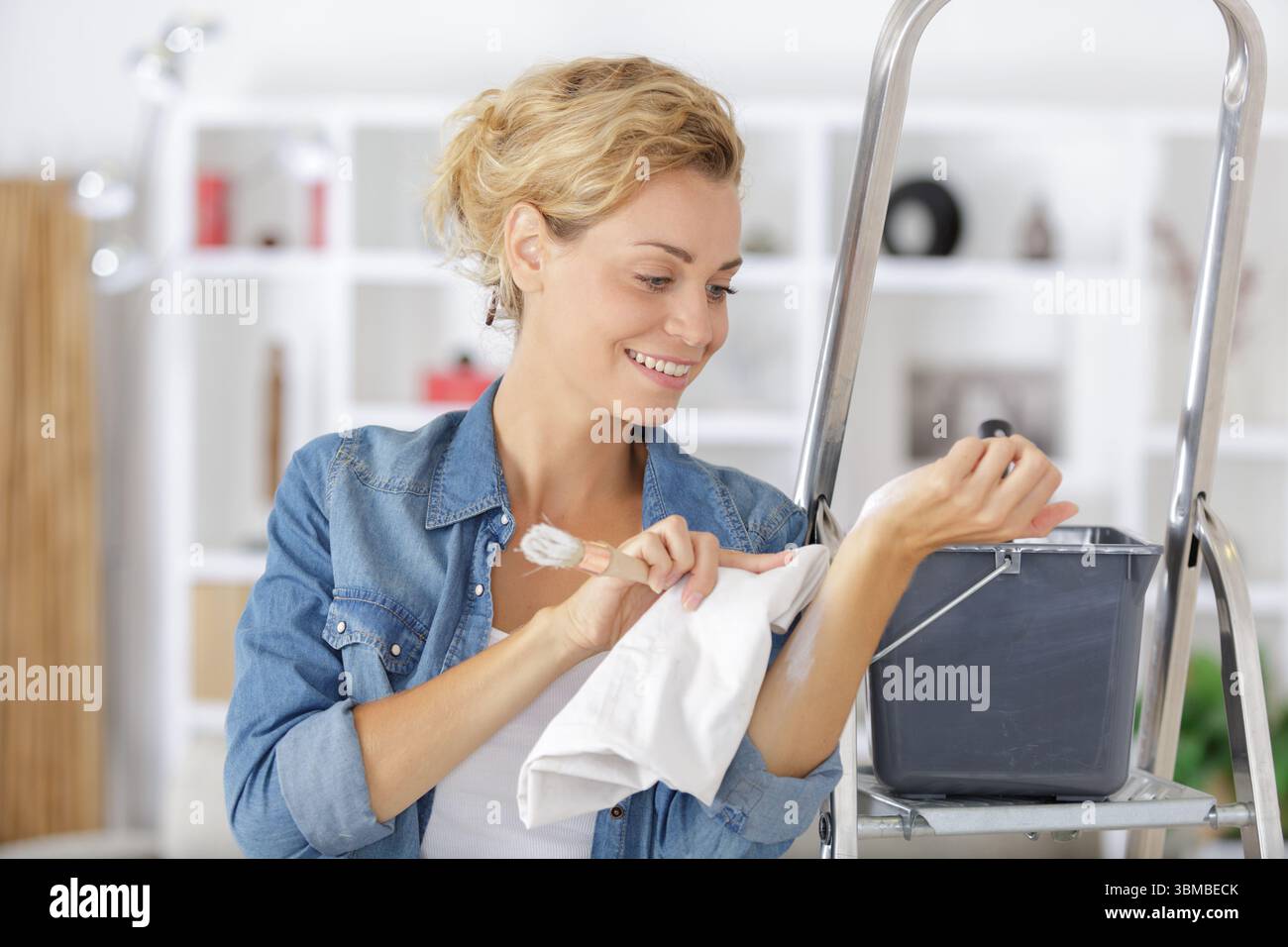 woman cleaning hand after painting Stock Photo - Alamy