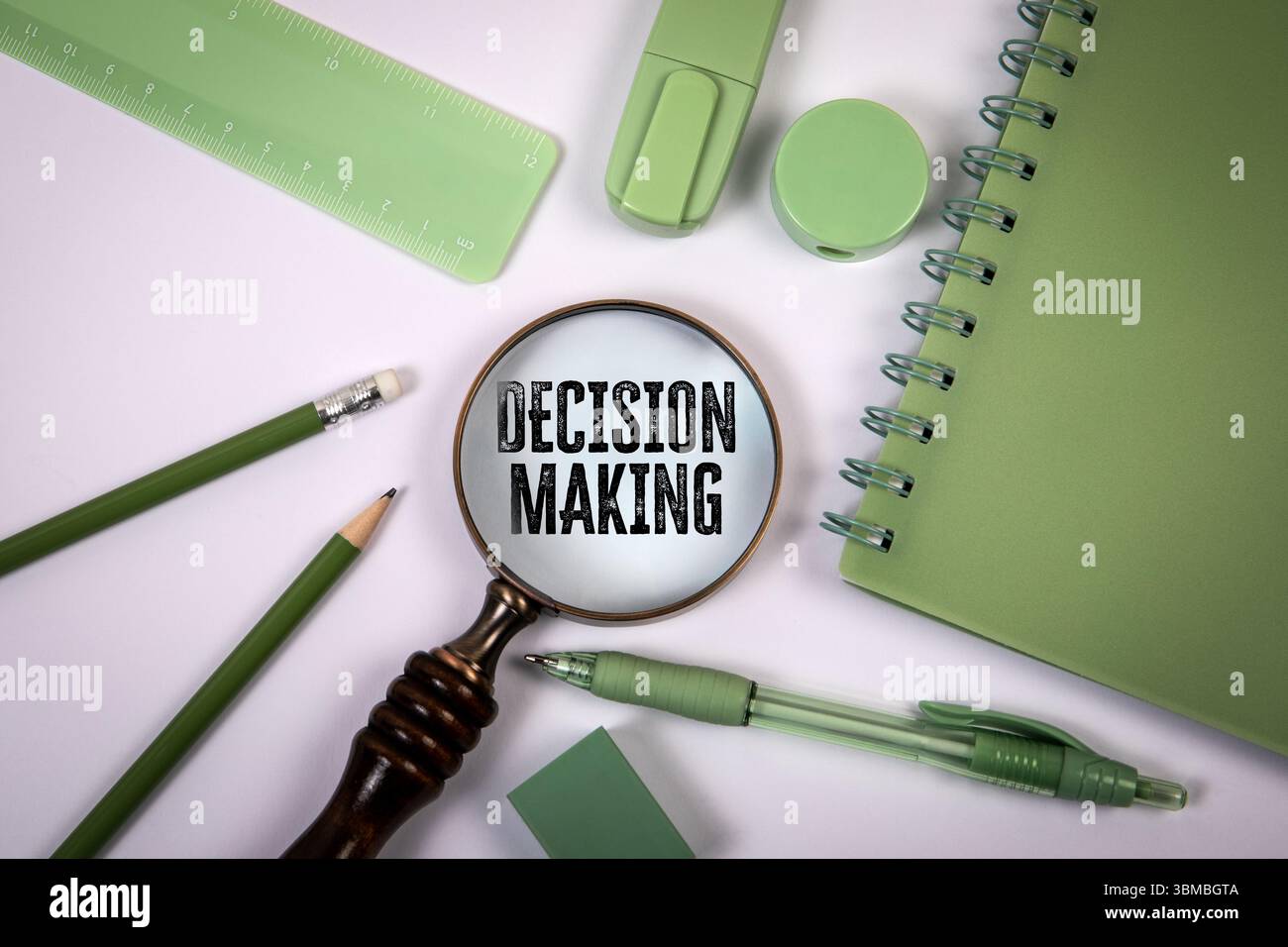 Decision Making Concept with Magnifying Glass and Green Office Supplies ...