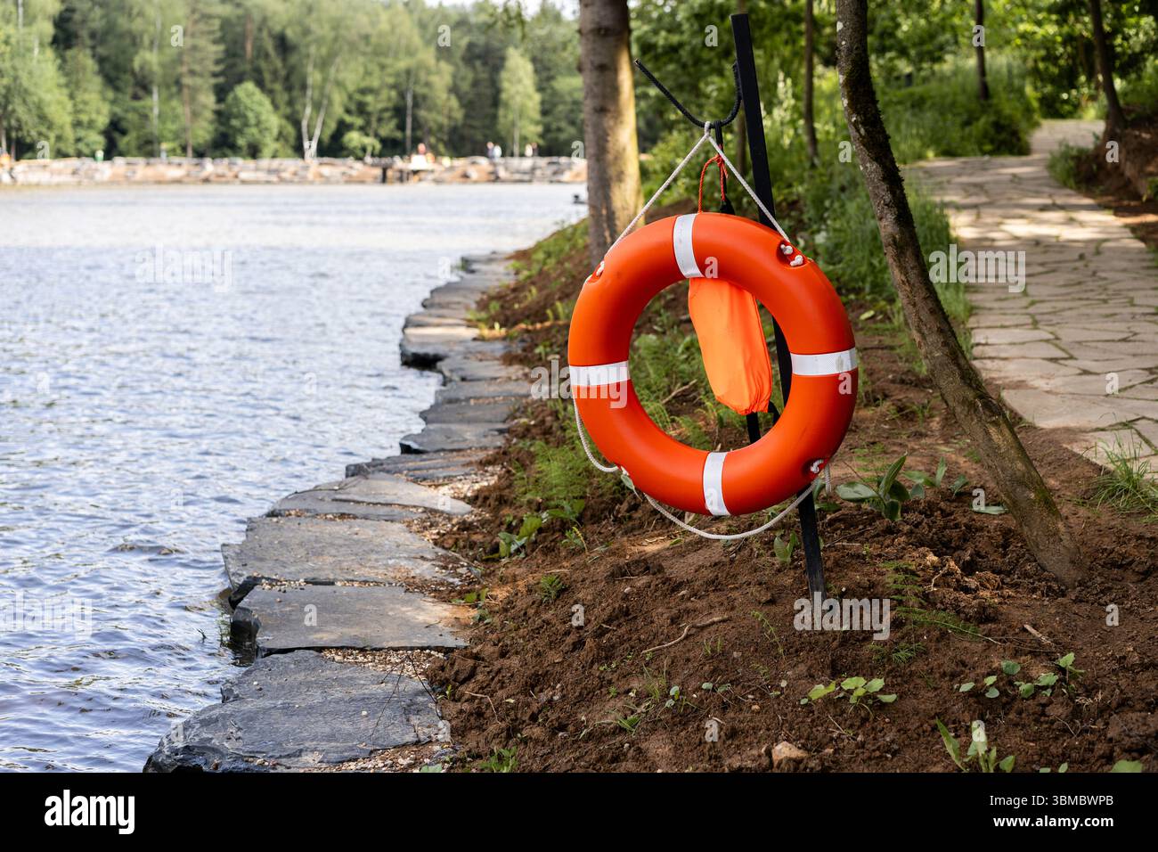 Bright Lifebuoy on Lakeside Path Stock Photo - Alamy