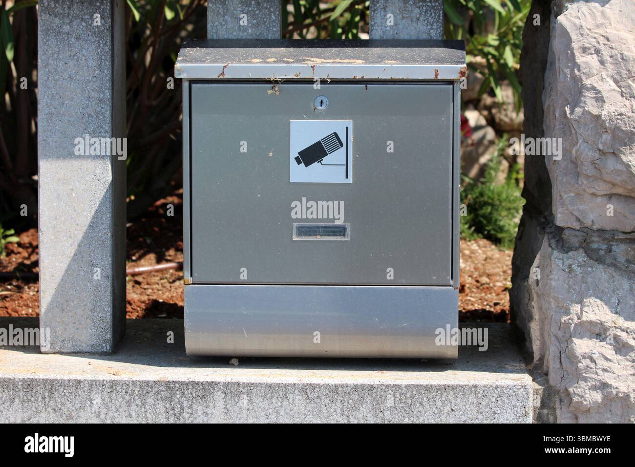 Rectangular gray metal mailbox with a surveillance camera symbol ...