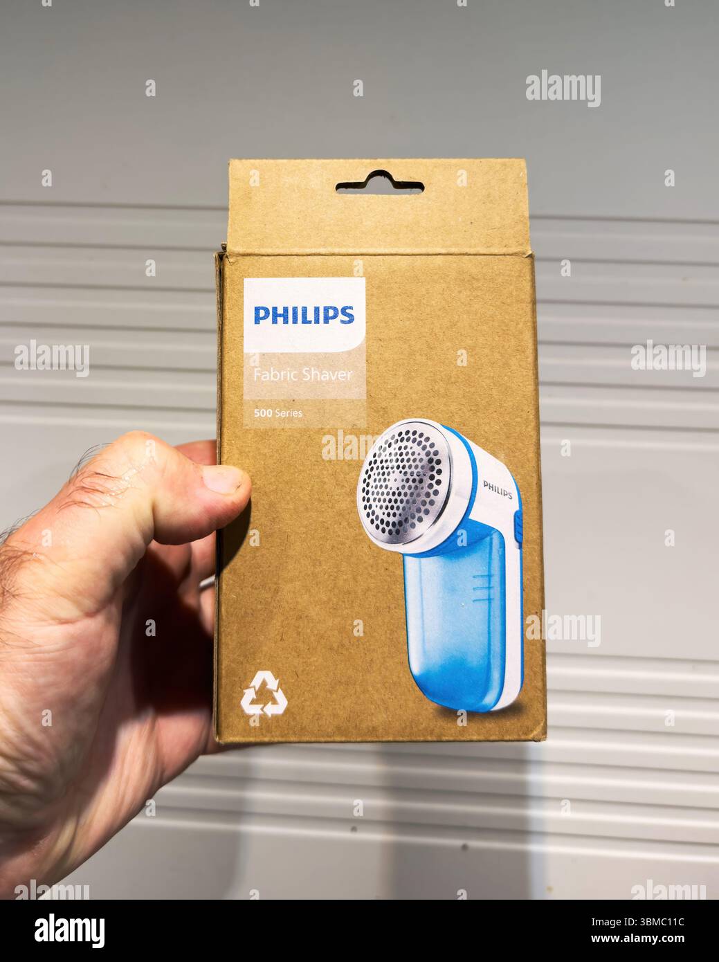 Ulm, Germany - May 6, 2025: A hand displays the Philips Fabric Shaver ...