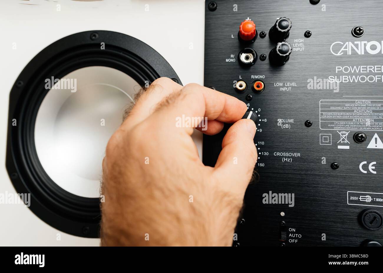 Paris, France - Nov 29, 2024: Person hand adjusting the volume knob on ...