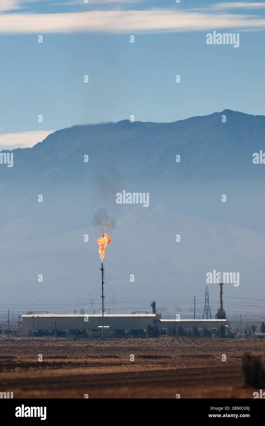 An industrial facility in Iran with a torch burning associated gases ...