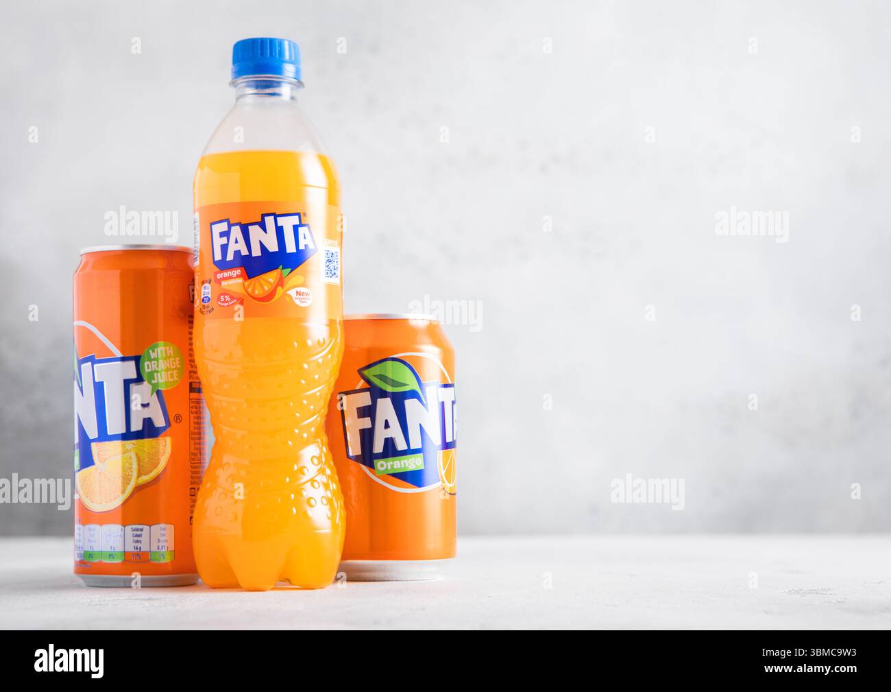 LONDON,UK - MAY 27,2025: Bottle and tins of Fanta original orange soda ...