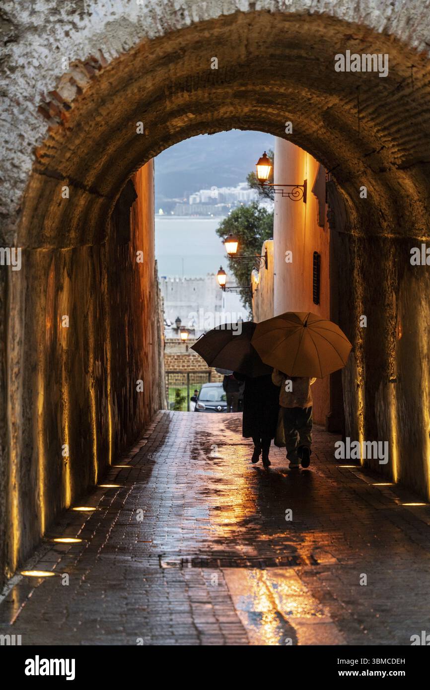 Illuminated alley next to the city wall, Tangier, Morocco, North Africa ...