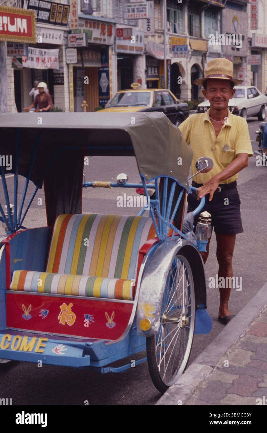 Malaysia. Penang. George Town. Malay man standing by his Trishaw. Photo ...