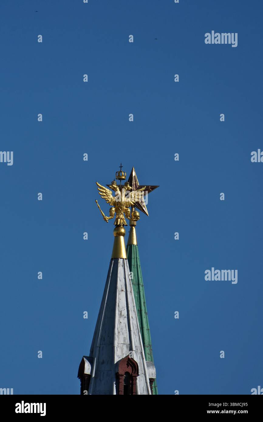 A golden eagle on a silver spire and a Soviet ruby star on a green ...