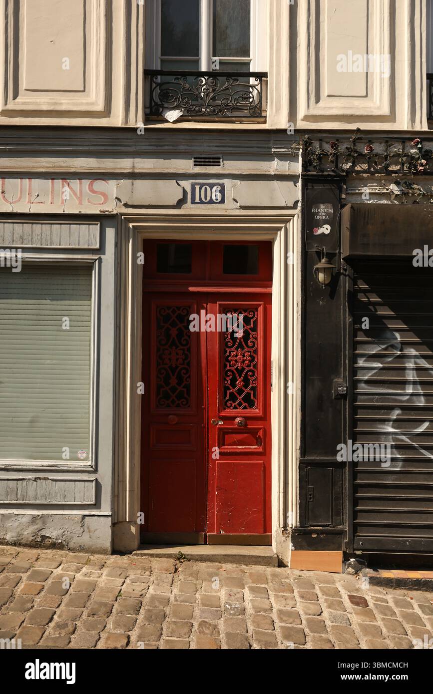 A photograph of a vibrant red door with intricate metalwork, set within ...