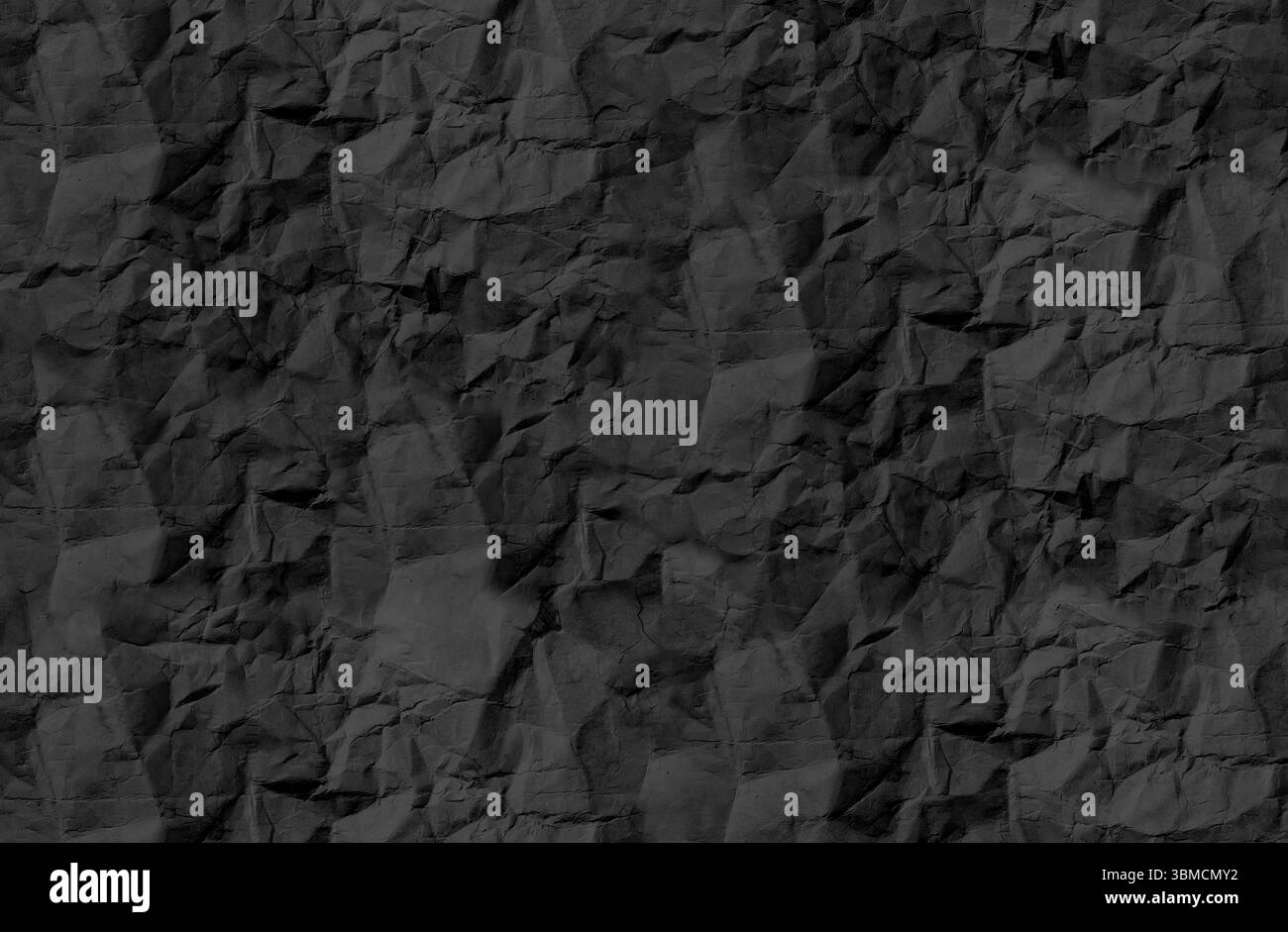 Crumpled black paper texture with rough, wrinkled surface and natural ...