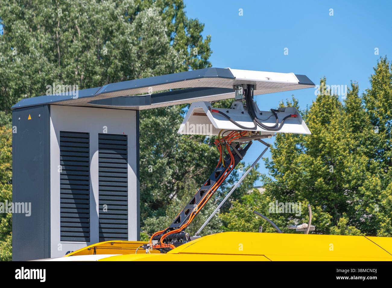 Electric bus charging station with roof-mounted pantograph in urban ...