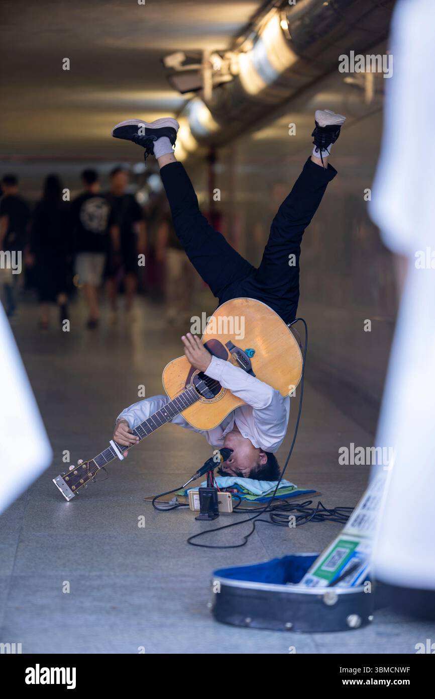 Street Photography: Man singing while standing upside down Stock Photo ...