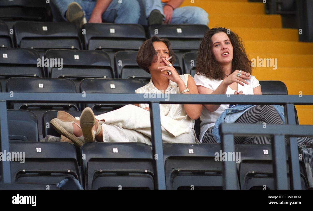 Female football fans enjoy a cigarette while watching Notts County V ...
