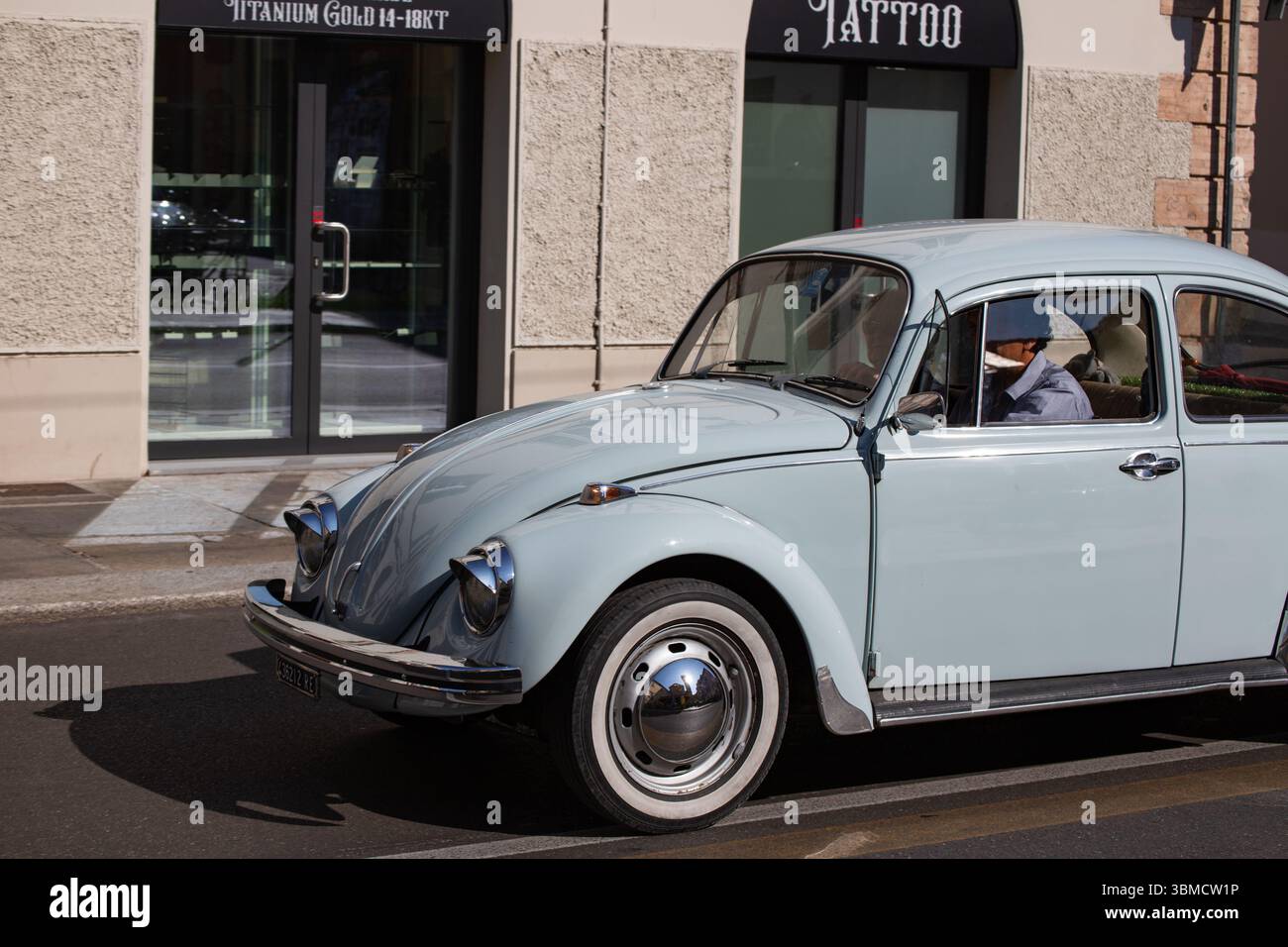Vintage light blue Volkswagen Beetle parked on a charming urban street ...