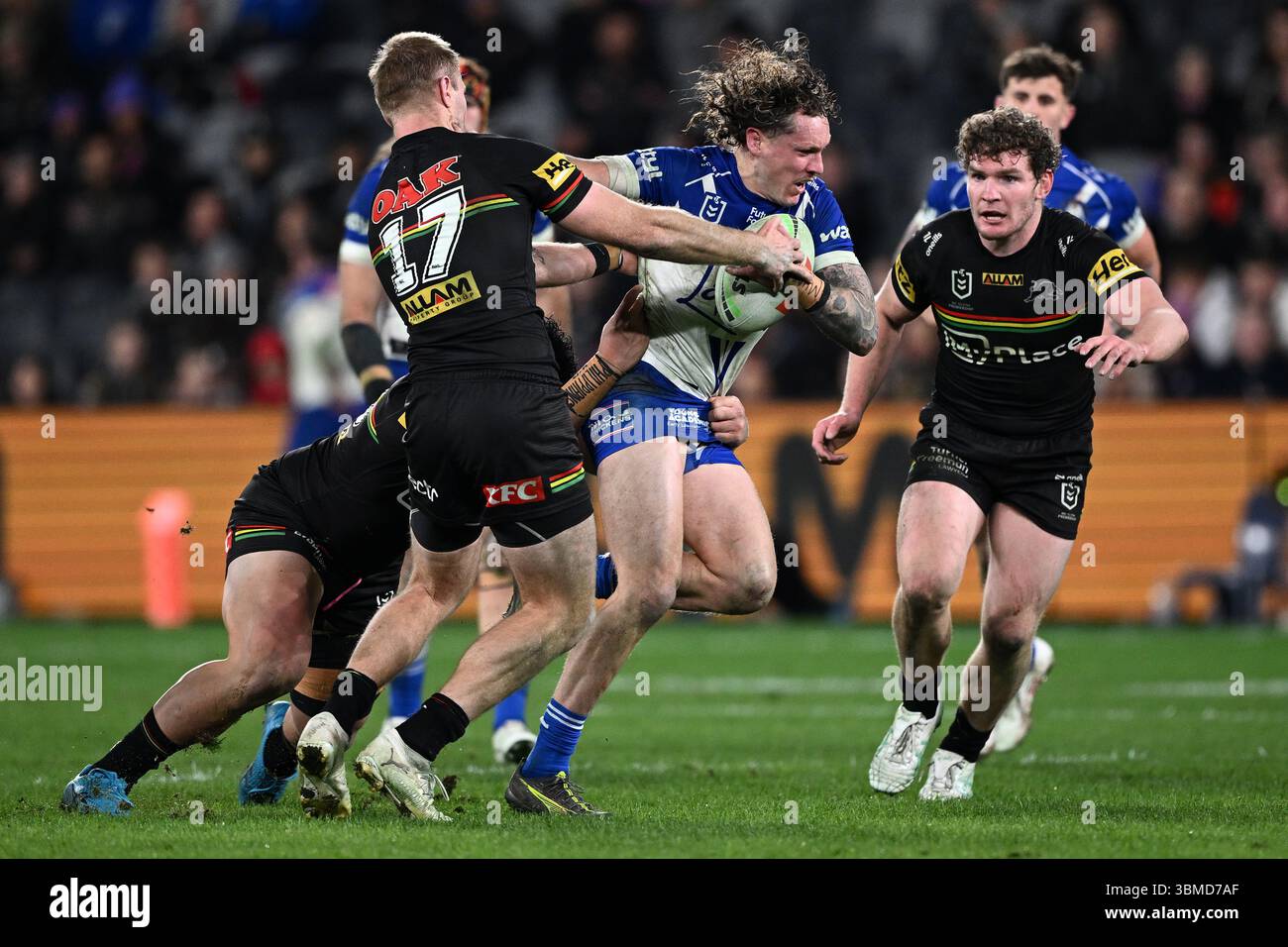 Kurt Mann of the Bulldogs is tackled by Luke Garner of the Panthers ...