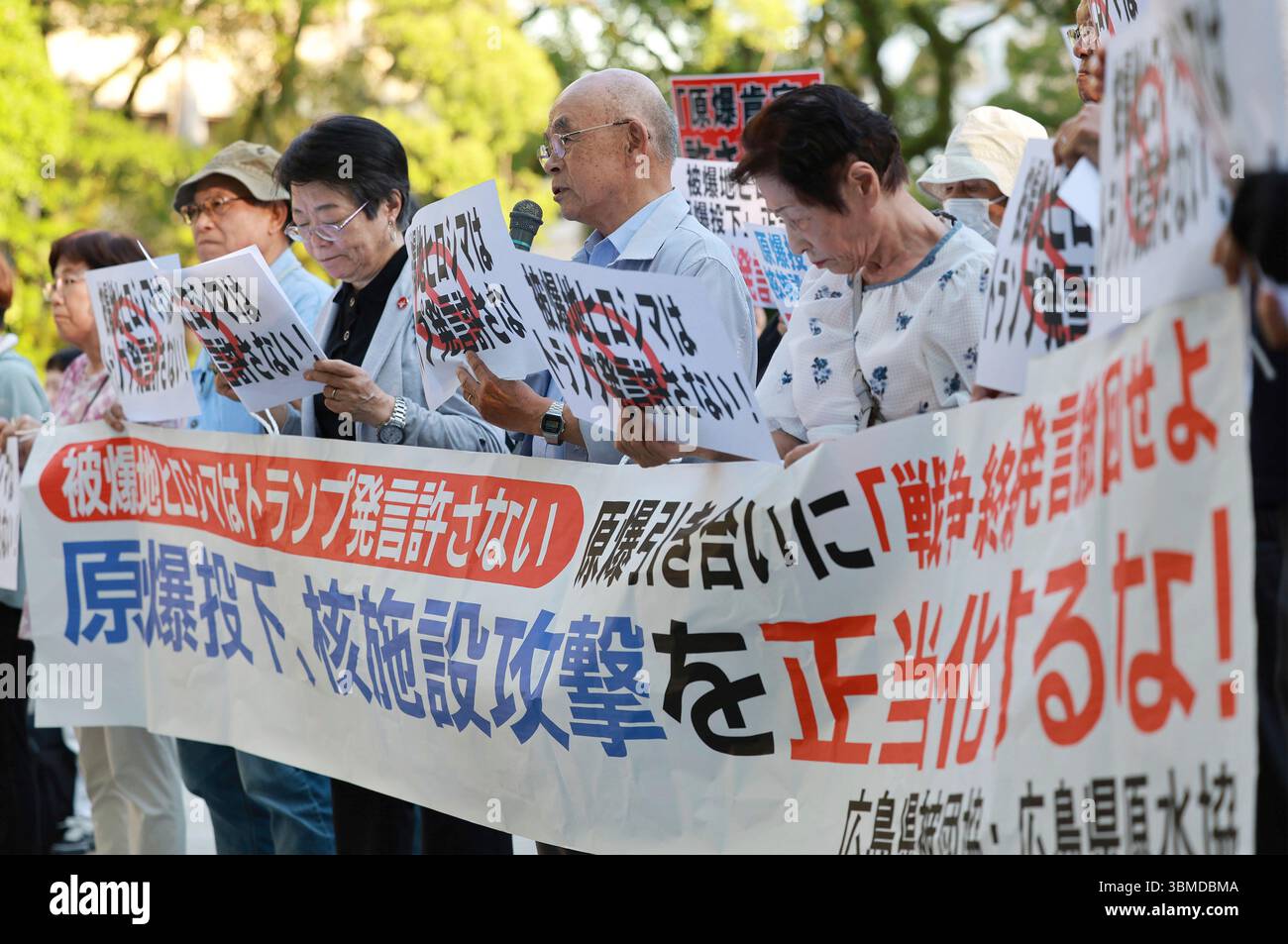 Survivors of the atomic bomb protest in front of the Atomic Bomb Dome ...