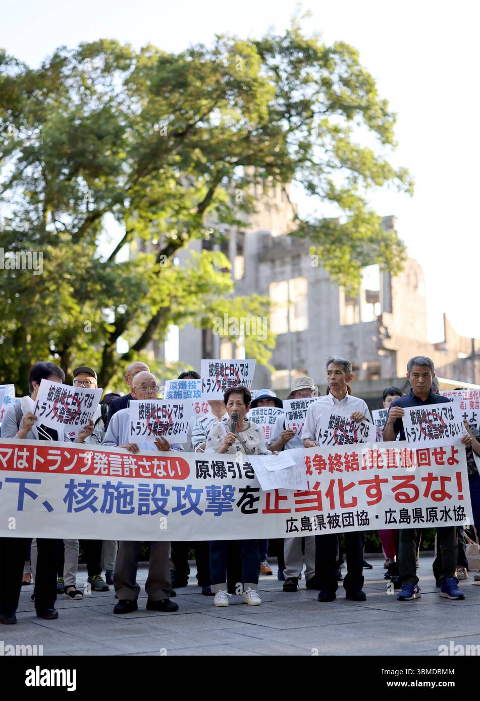 Survivors of the atomic bomb protest in front of the Atomic Bomb Dome ...