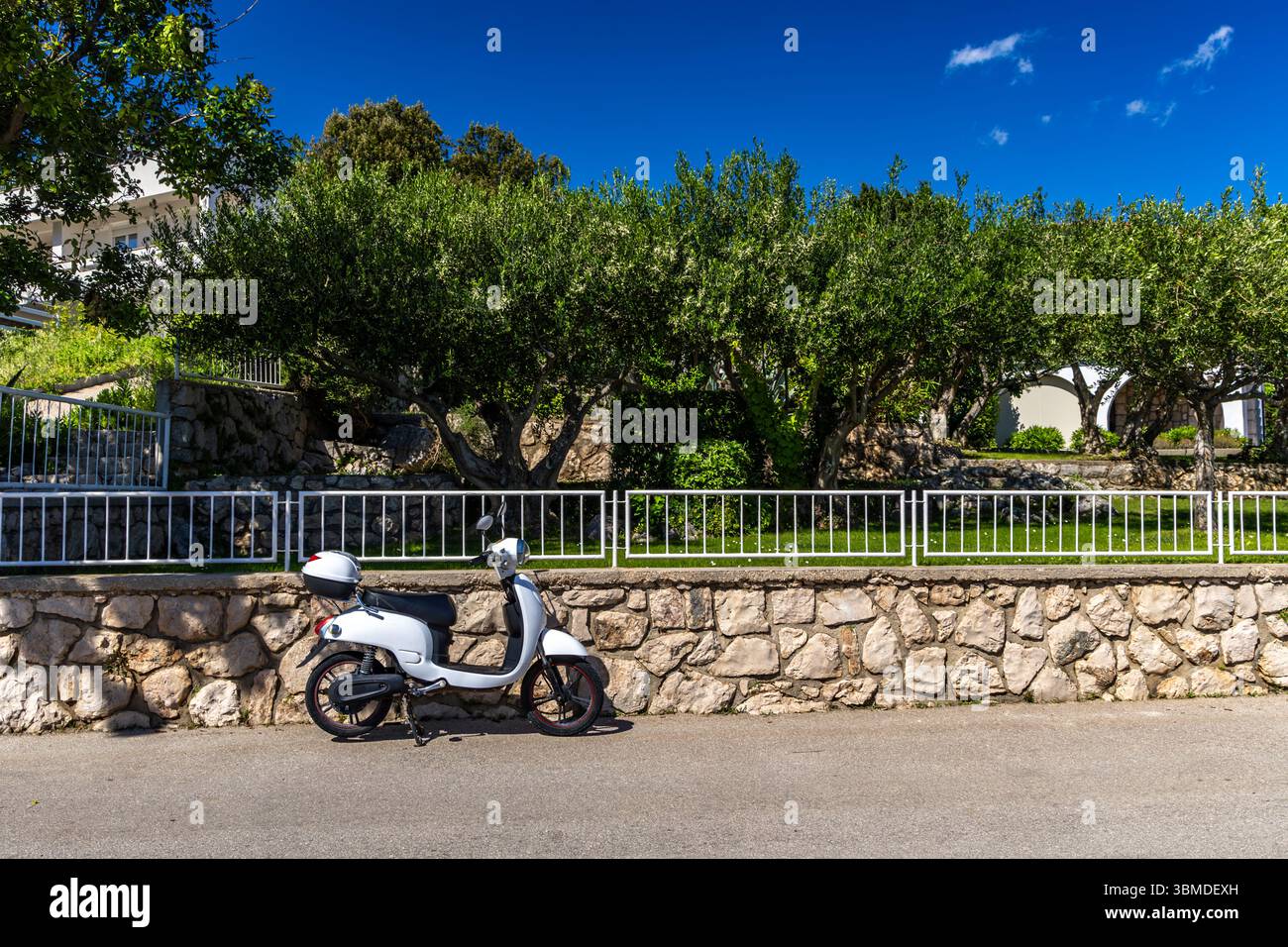 White scooter, motorized postman, delivering parcels on a scooter Stock ...