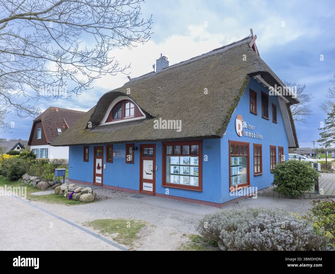 Blue house with thatched roof by Reiser Immobilien in Ahrenshoop on the ...