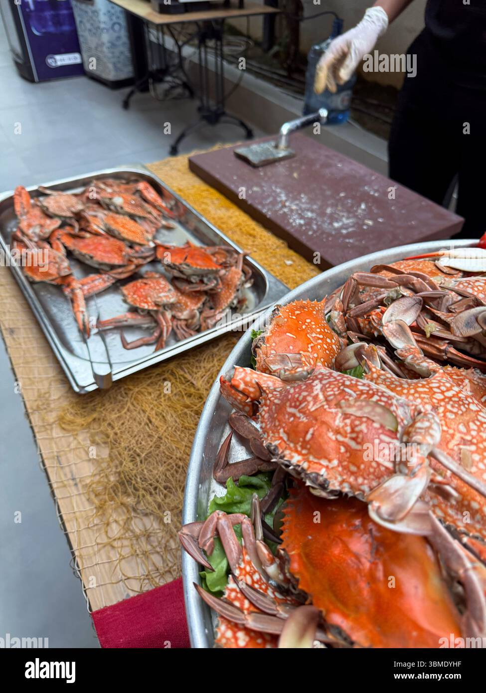 Chef Serving Crab at Open-Air Hotel Buffet Station. Crabs served at a ...