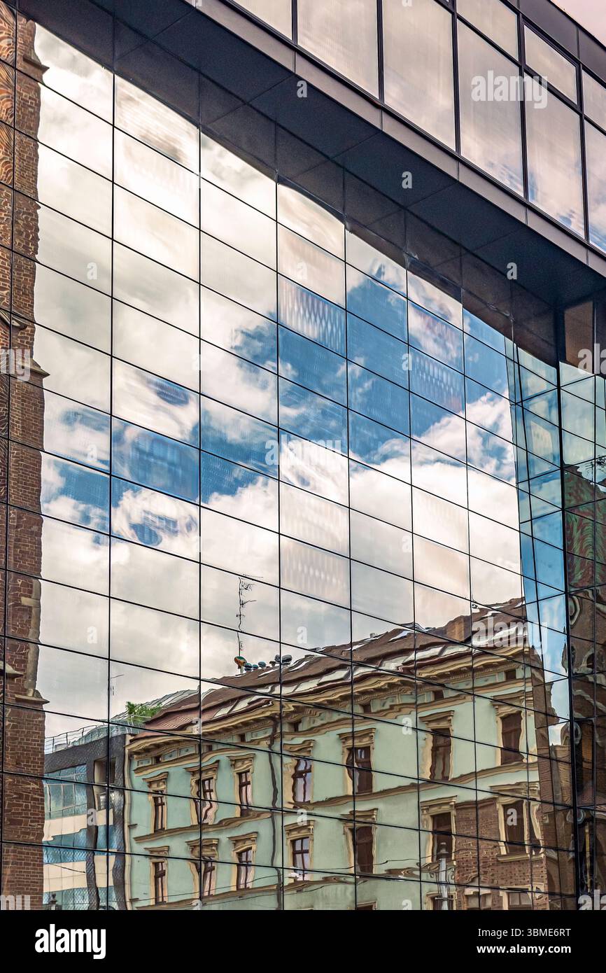 Urban architecture where a contemporary glass building reflects the ...