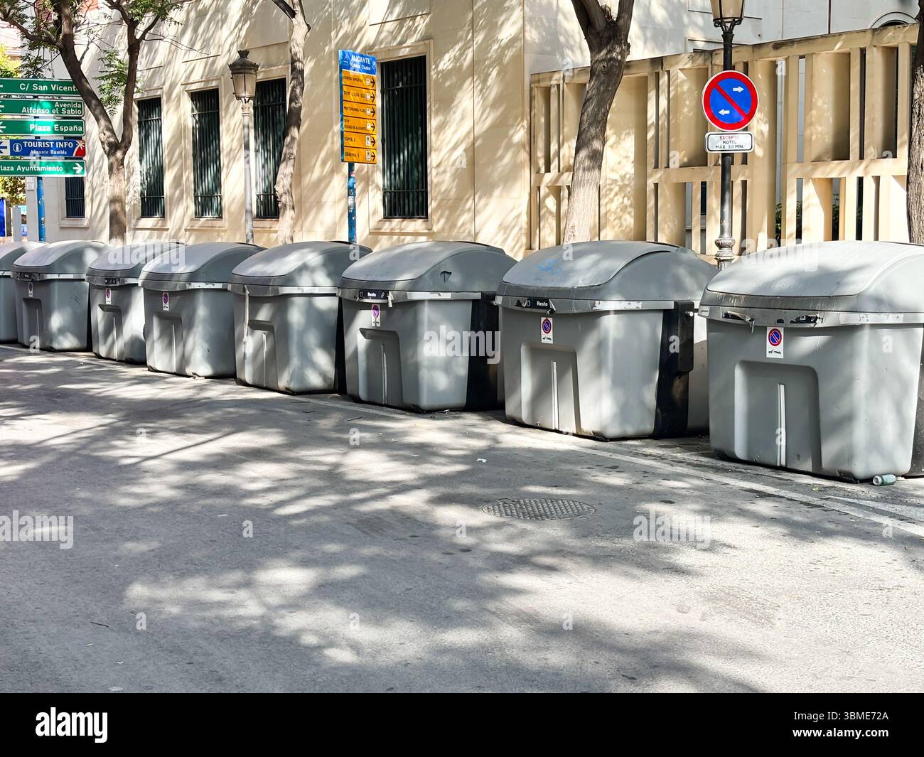 Alicante, Spain - June 24, 2025: Row of modern gray waste bins lined up ...