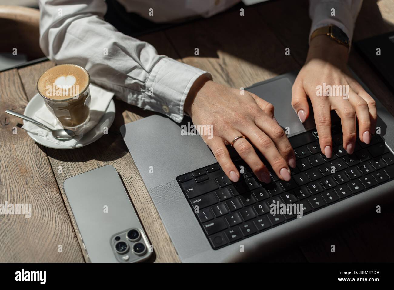 Woman In White Shirt Typing On Laptop In A Sunny Workspace. Freelance ...