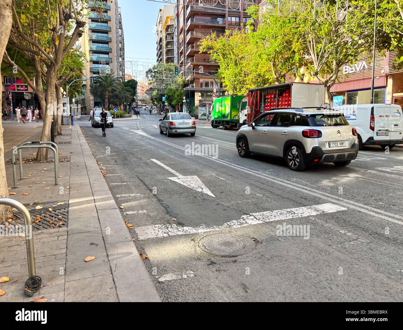 Alicante, Spain - June 24, 2025: Busy urban street scene with vehicles ...
