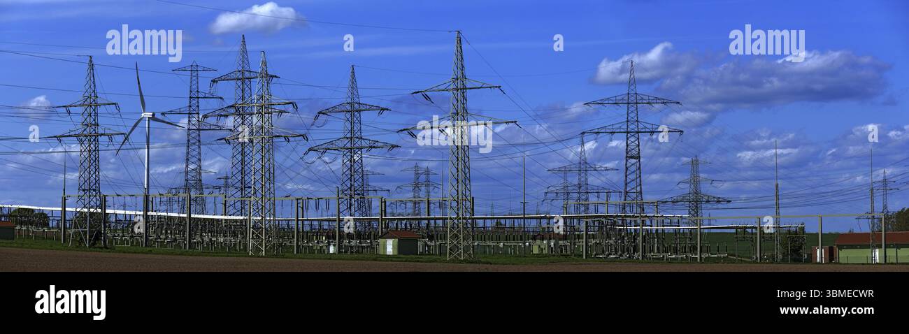 Power pylons with high-voltage lines and wind turbines at the Avacon ...