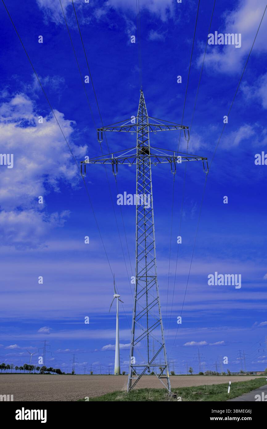 Power pylons with high-voltage lines and wind turbines at the Avacon ...