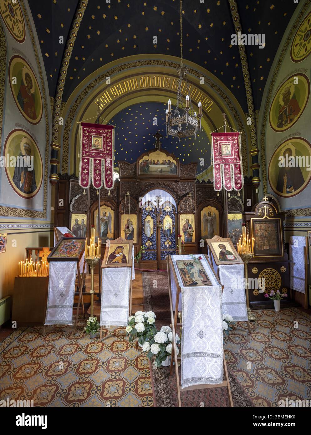 Russian chapel, interior with rosewood iconostasis, icons and candles ...
