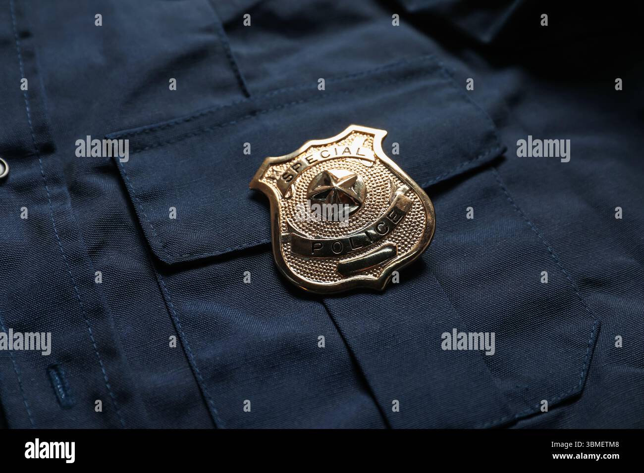 Police badge on dark blue uniform, closeup Stock Photo - Alamy