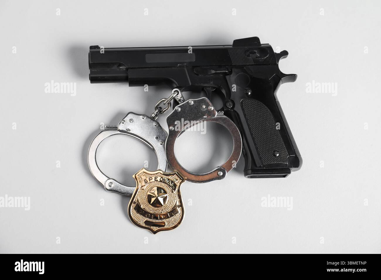 Police badge, gun and handcuffs on white background, above view Stock ...