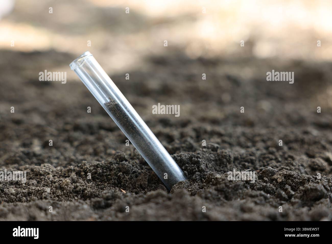 Test tube with soil sample outdoors, closeup. Space for text Stock ...