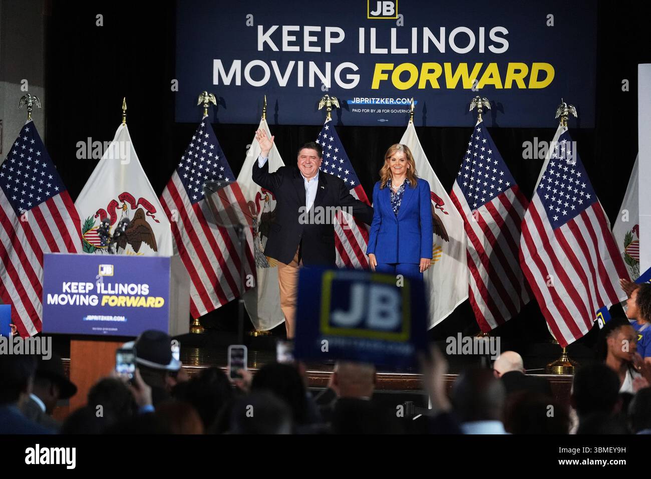 Illinois Governor JB Pritzker, left, waves to supporters as he enters ...