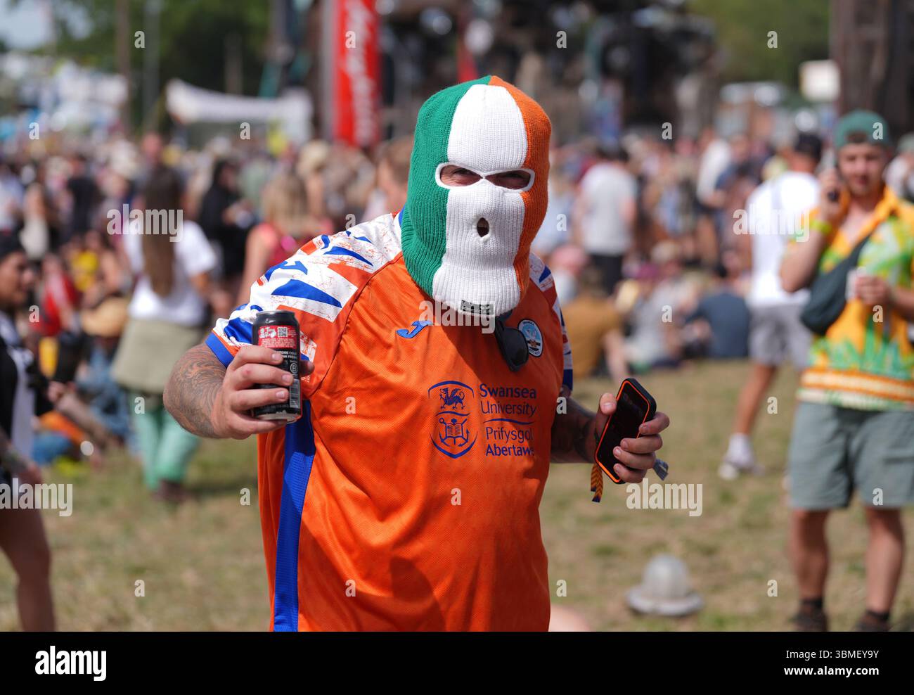 A festivalgoer wearing a tricolour Balaclava, similar to the one worn ...