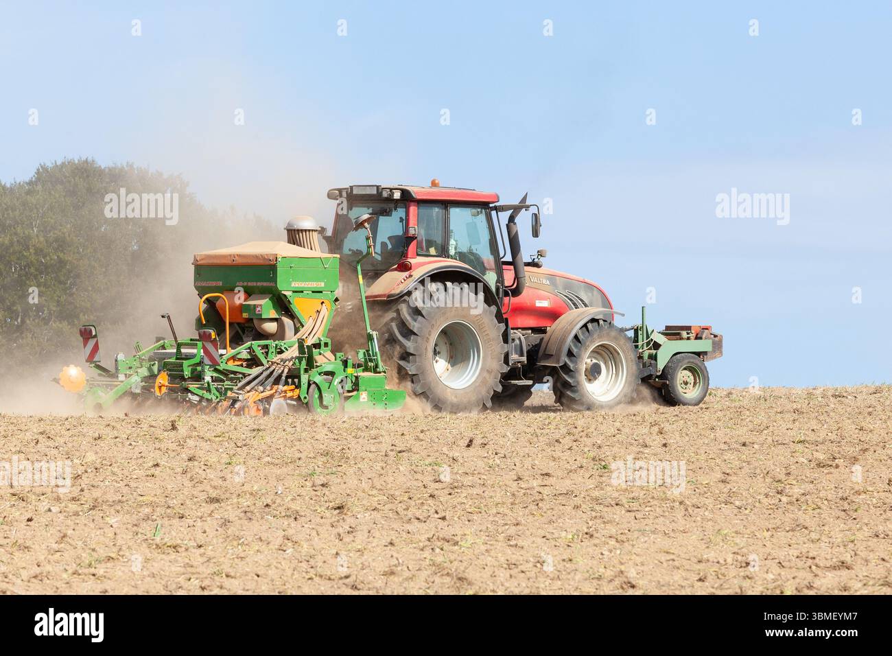Farmer planting crops with an Amazone AD-P-303 SPECIAL pneumatic harrow ...