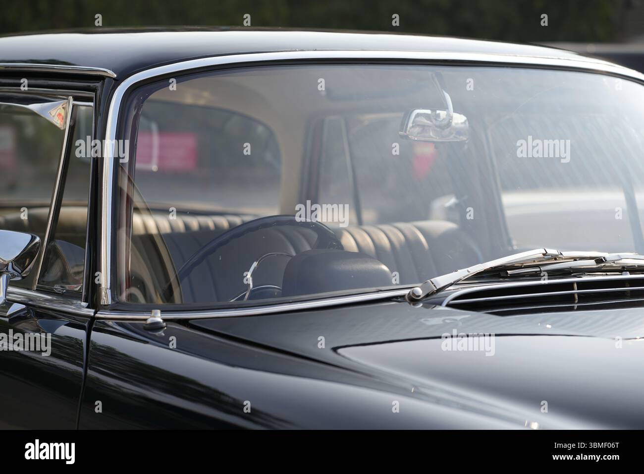 The windshield and chrome wipers of a classic car showcase the timeless ...