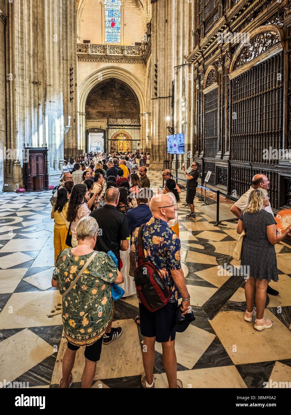 Seville, Spain, June 18 2025, Tourists line up inside Seville's ...