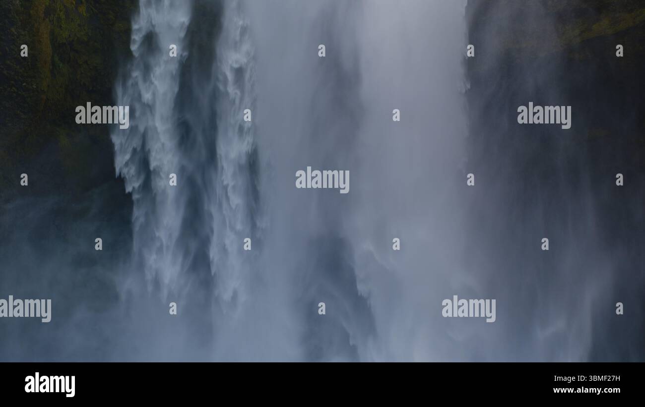 Powerful water flows from the heights of the cliffs, creating mist that ...