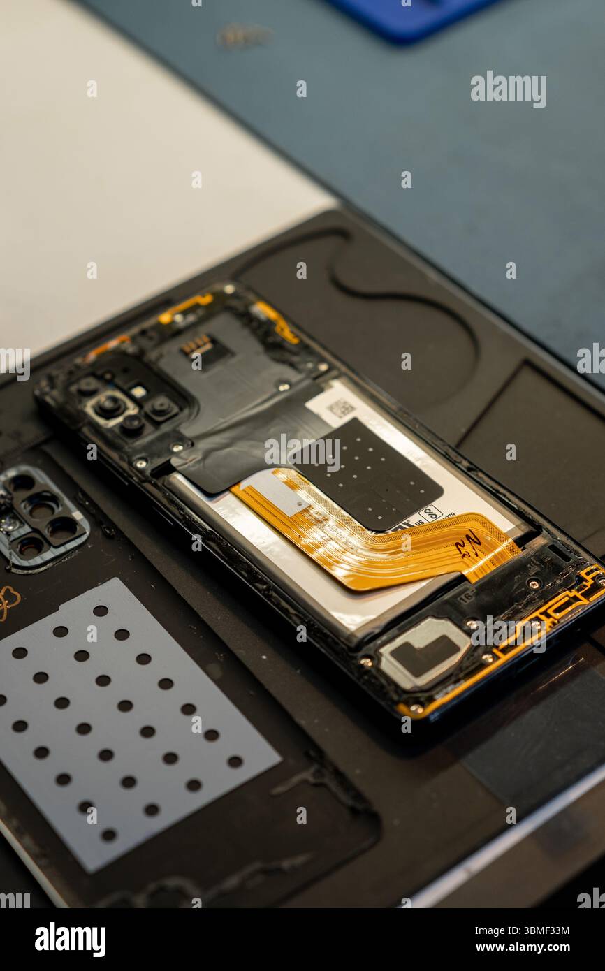 Expert Technician Performing Phone Repair on Disassembled Smartphone ...