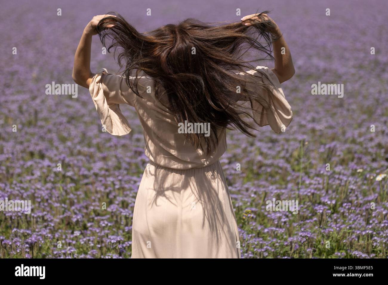 Woman long flowing hair standing hi-res stock photography and images ...