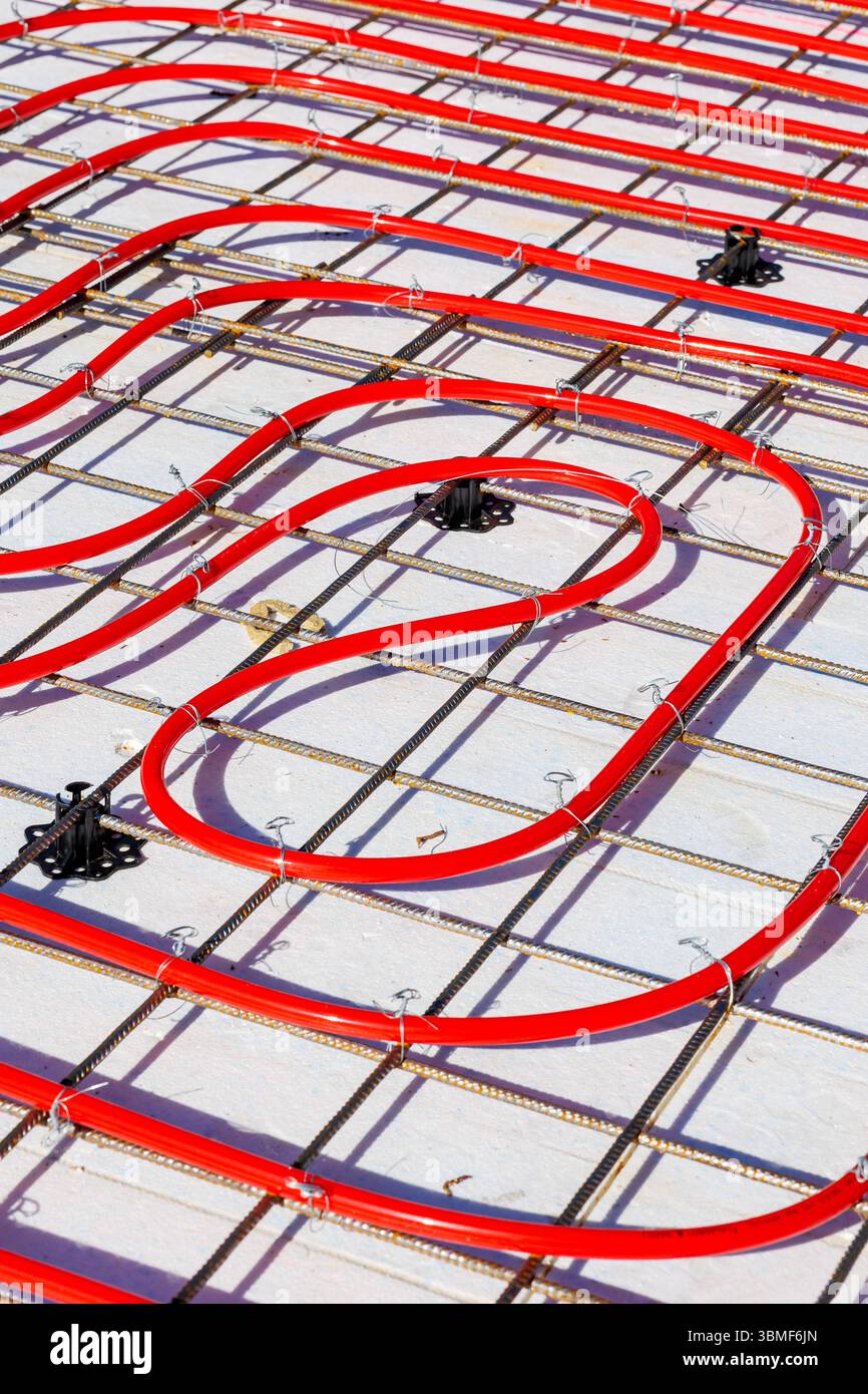 Underfloor heating system with red pipes on construction site Stock ...