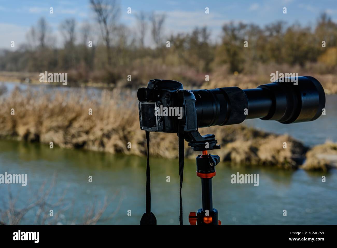 A Camera With A Long Telephoto Lens Stands On A Sturdy Tripod On The ...