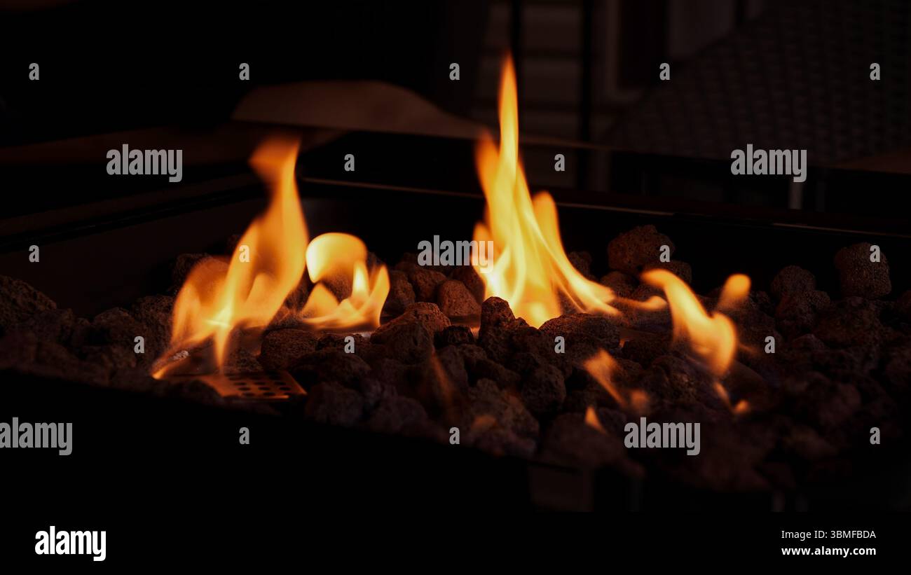 Warm Flames Dancing At Night In A Fire Pit With Lava Rocks for Cozy ...