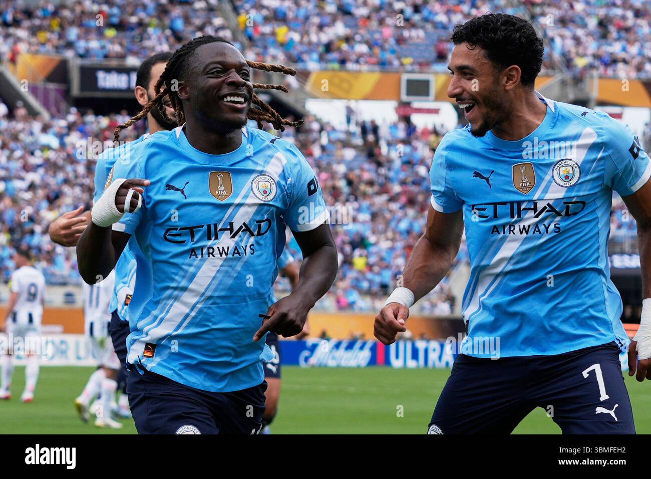Manchester City's Jeremy Doku, left, celebrates after scoring during ...